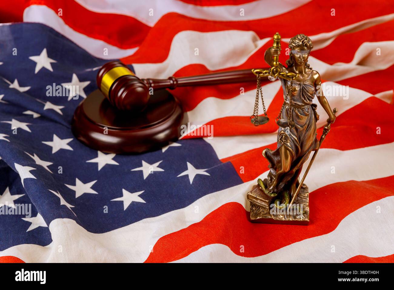 Lady Justice holds bronze statue of Justice beside Judicial gavel on ...