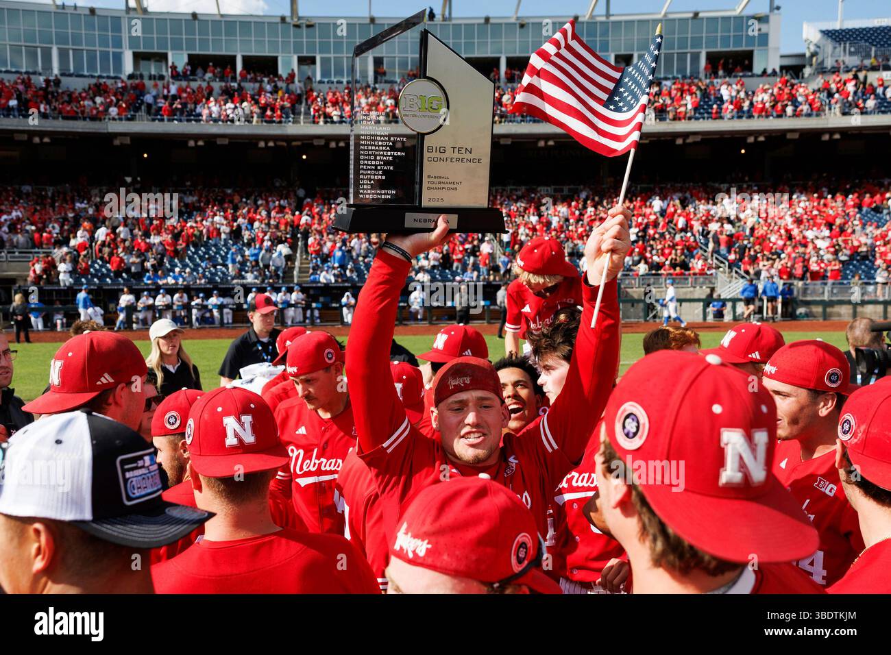 Nebraska's Joshua Overbeek, center, hoists the trophy after his team ...