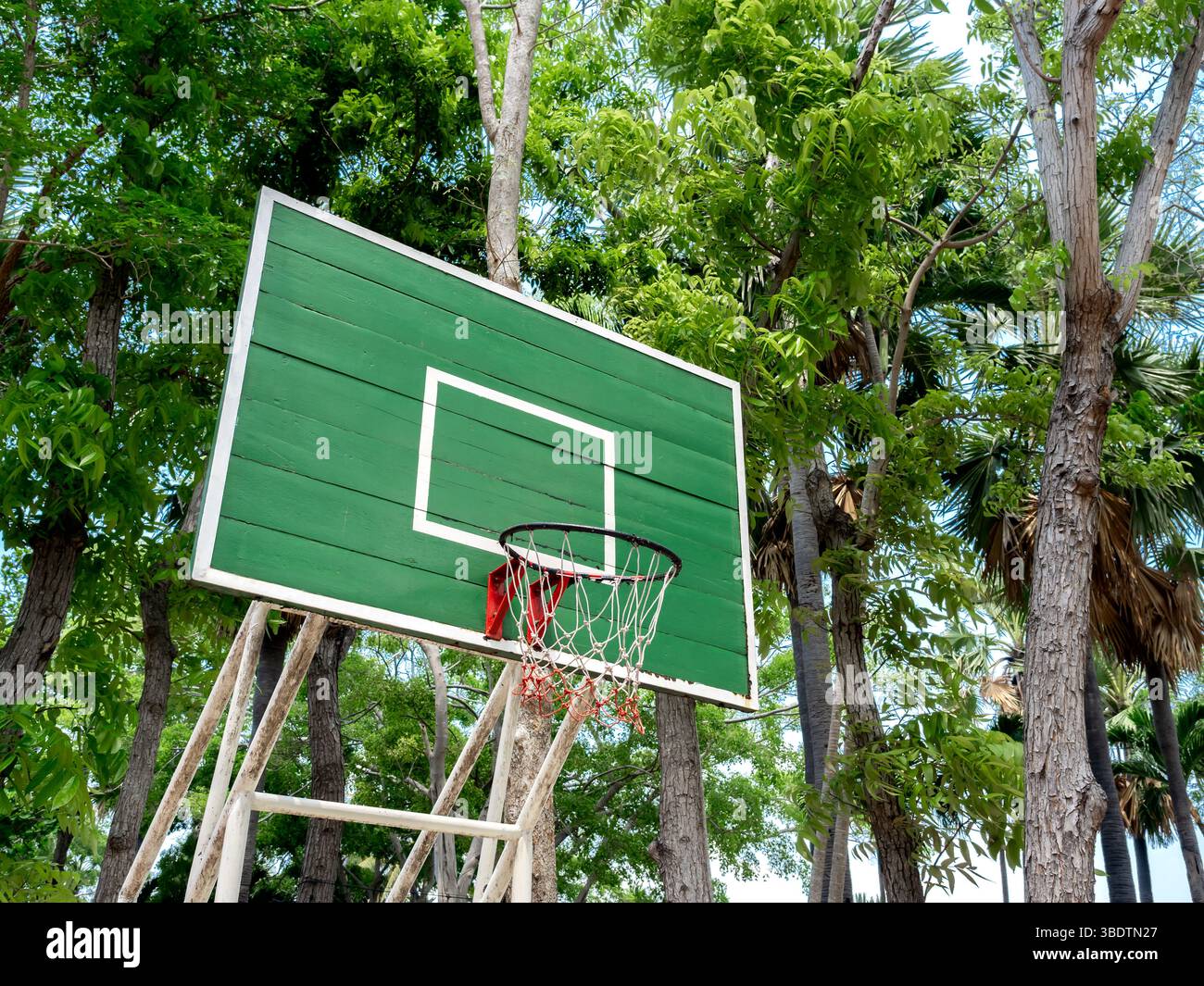 Old empty basketball hoop made by green wood panels with net in the ...