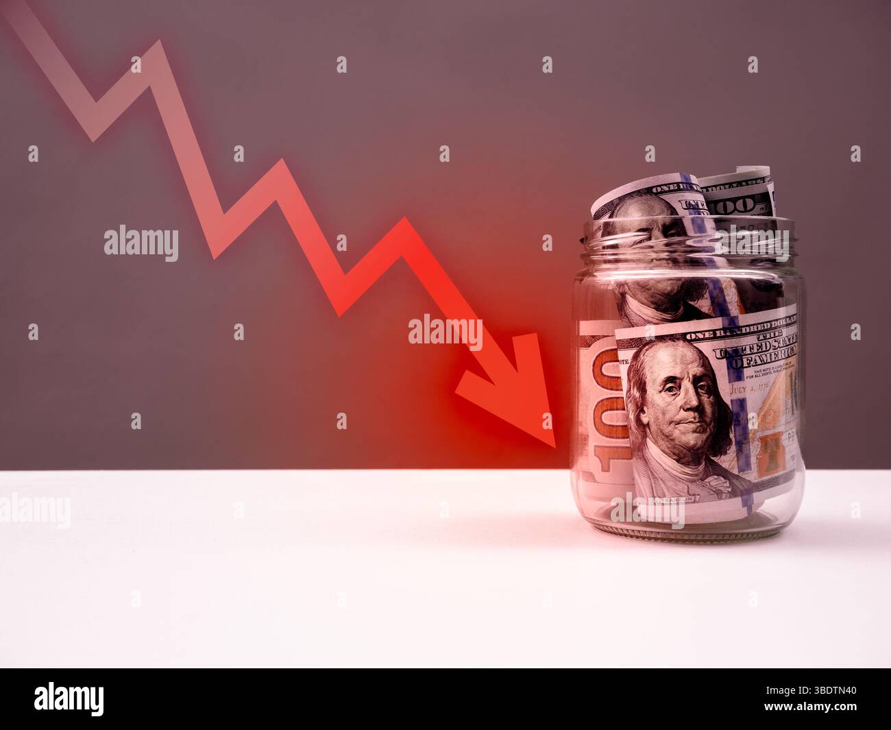 Red arrow shoots fall down at US dollars bill banknotes money cash ...