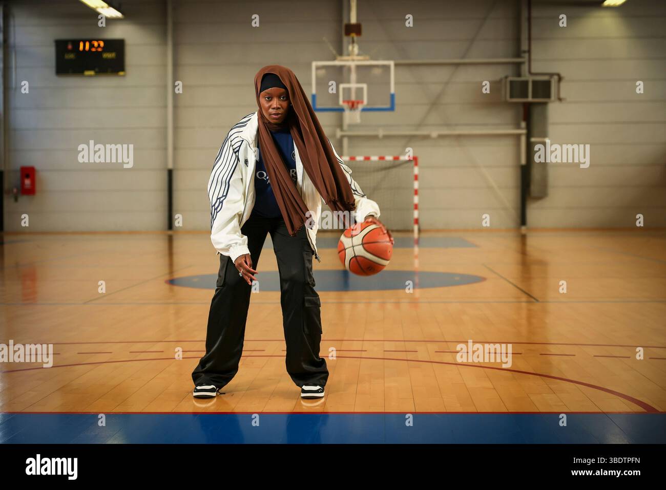Former player Salimata Sylla poses for a photo before a women's ...