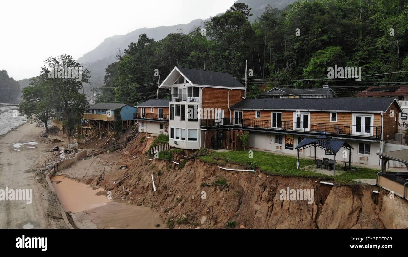 The Carter Lodge hangs precariously over the flood-scoured bank of the ...
