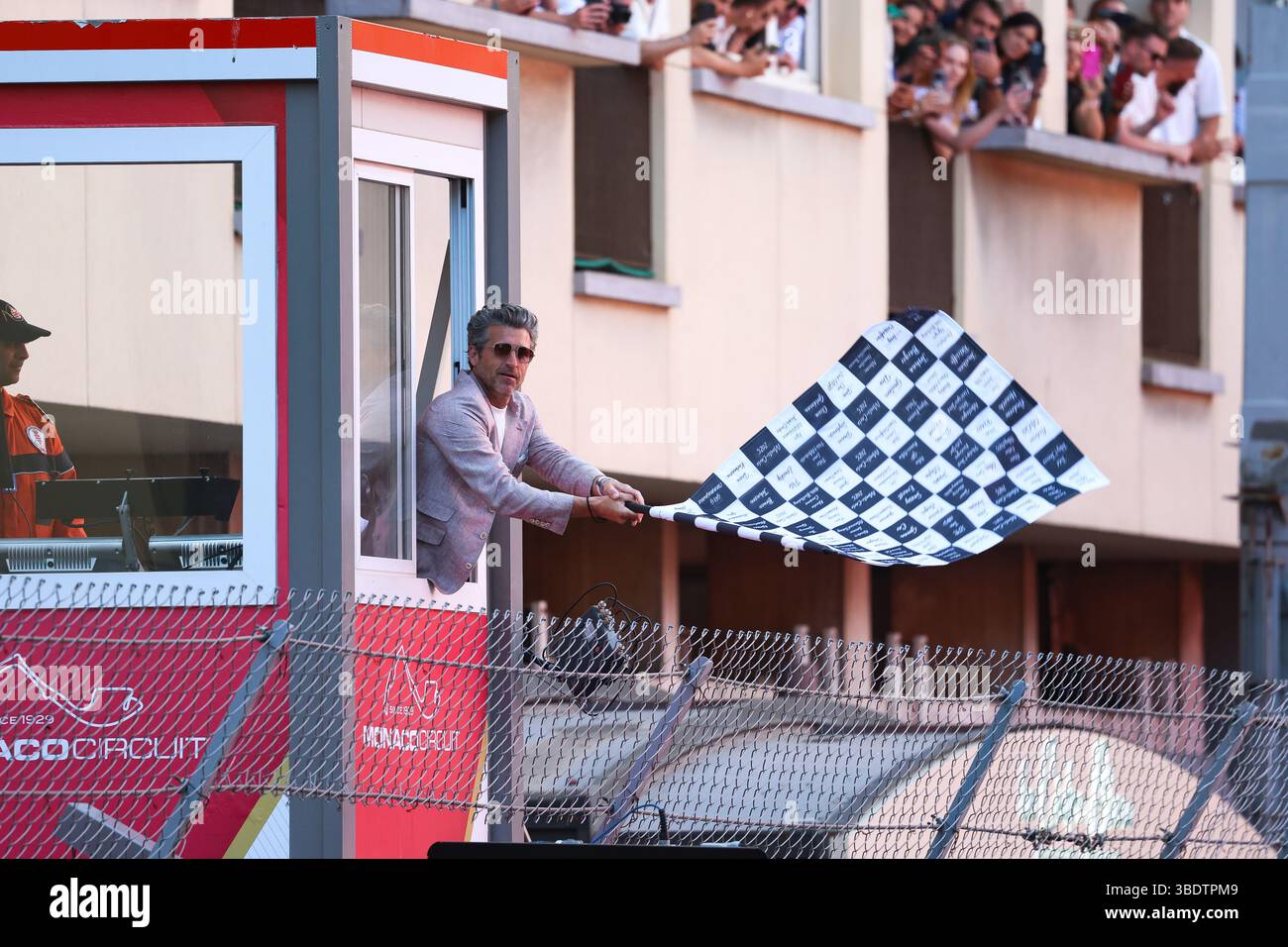 Patrick Dempsey waving the flag during the Formula 1 Tag Heuer Grand ...