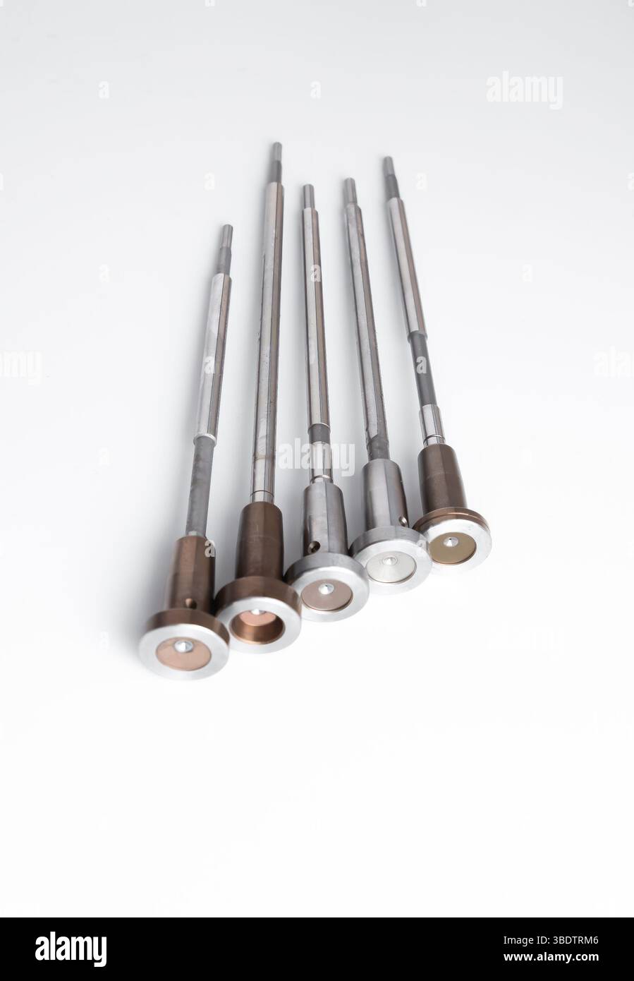 Five control valves standing vertically on white background. Automotive ...