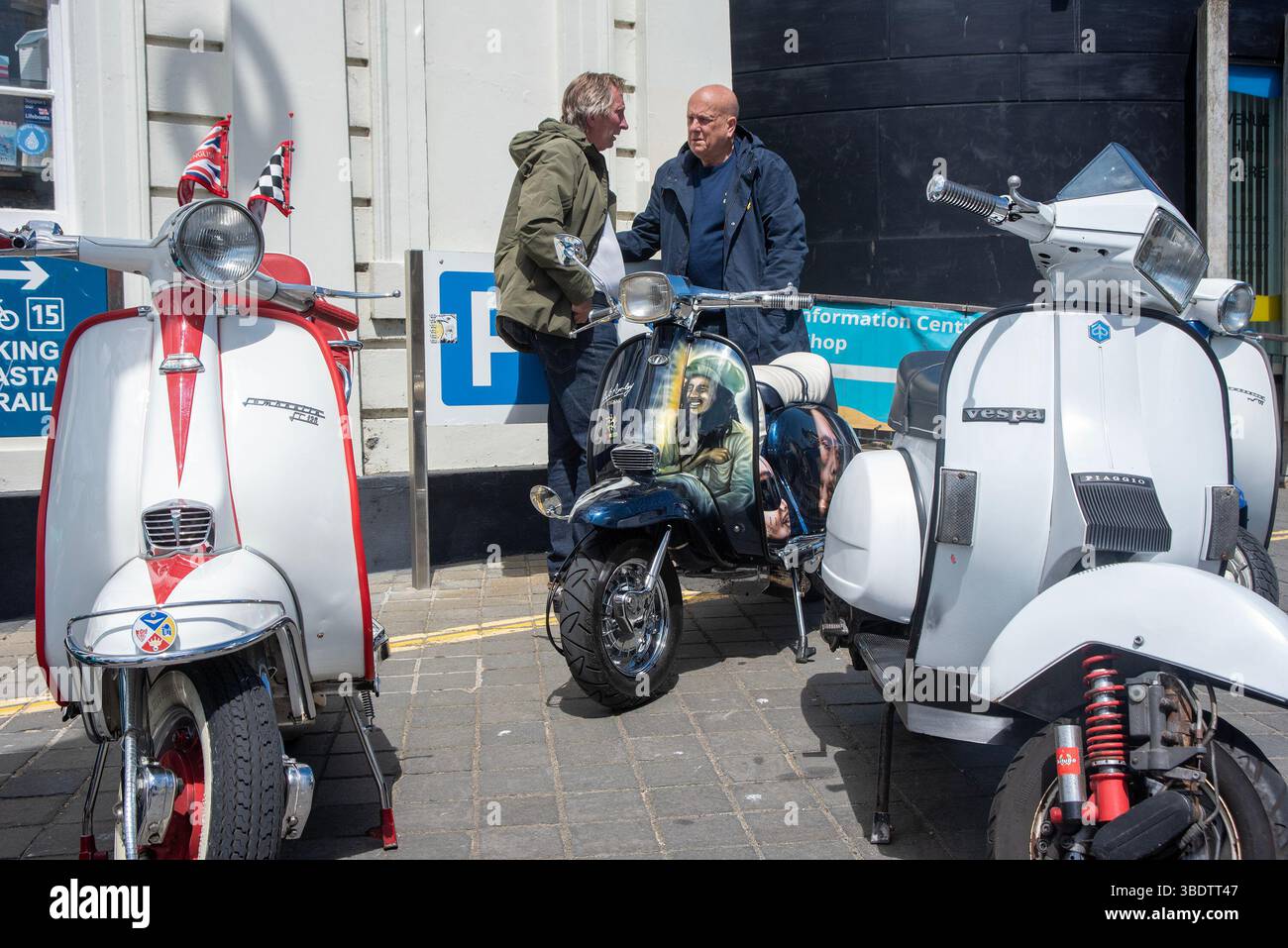 Margate, UK. 25th May, 2025. Two mods talk by a scooter which decorated ...