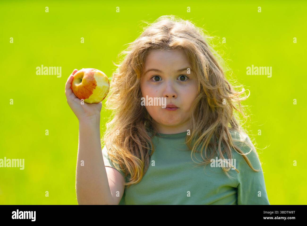 The child boy eats an apple. Ripe fruit for kids. Child bites apple ...