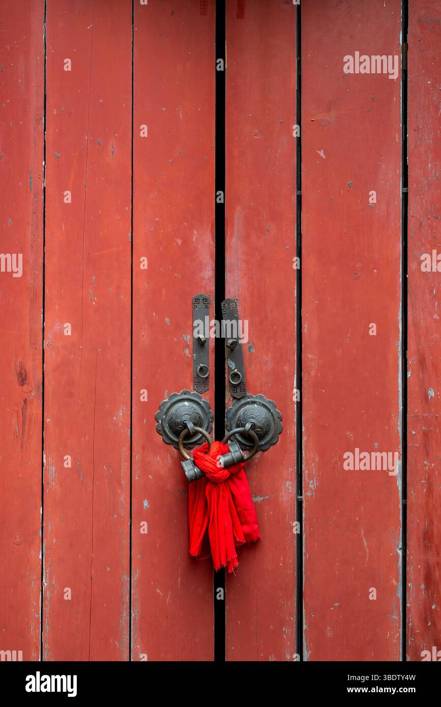 Red Wooden Door with Traditional Metal Hinges and Red Tassel Stock ...