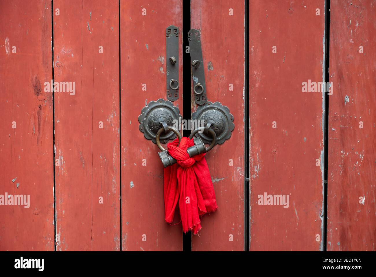 Red Wooden Door with Traditional Metal Hinges and Red Tassel Stock ...