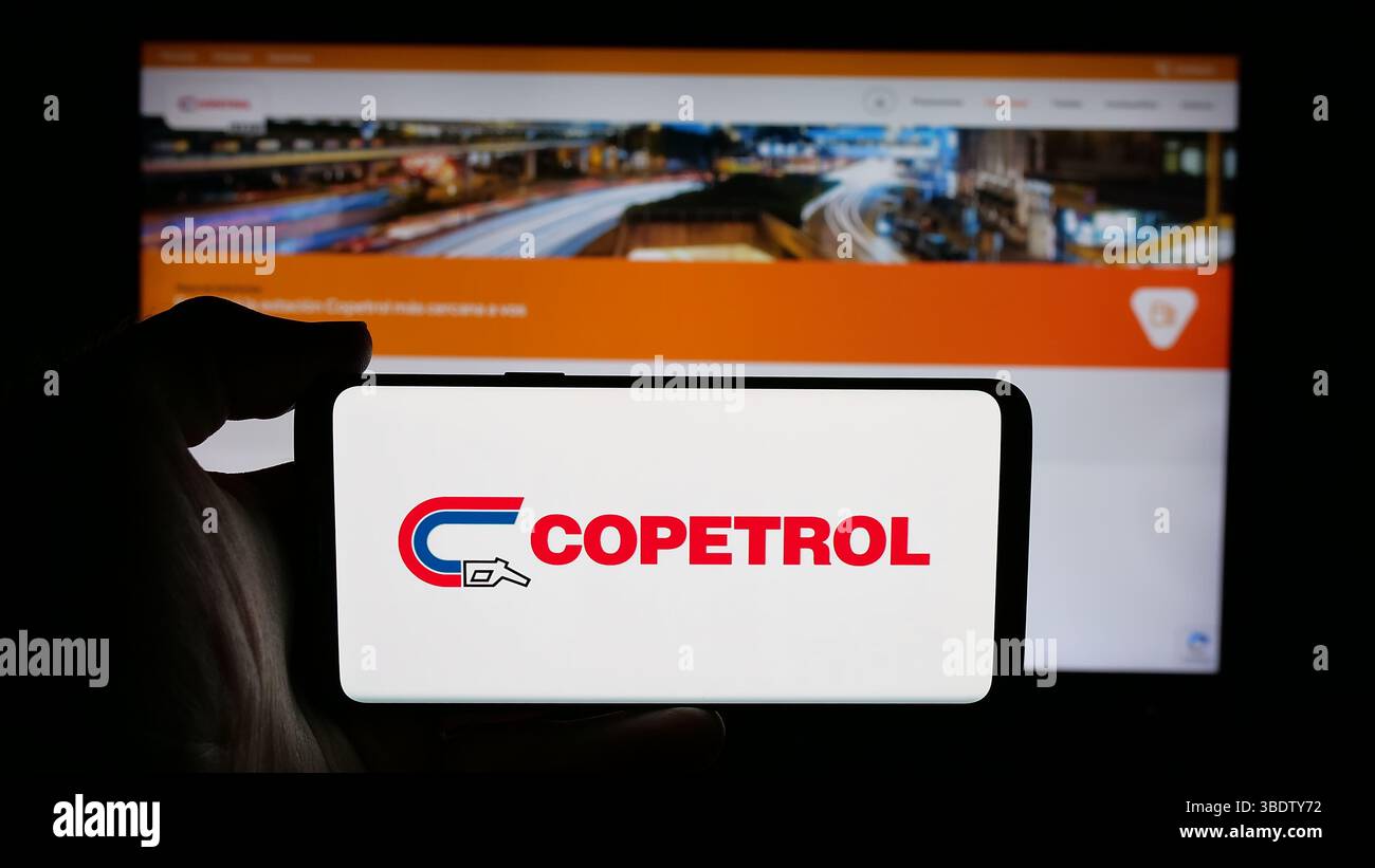 In this photo illustration, a person is holding a cellphone with the ...