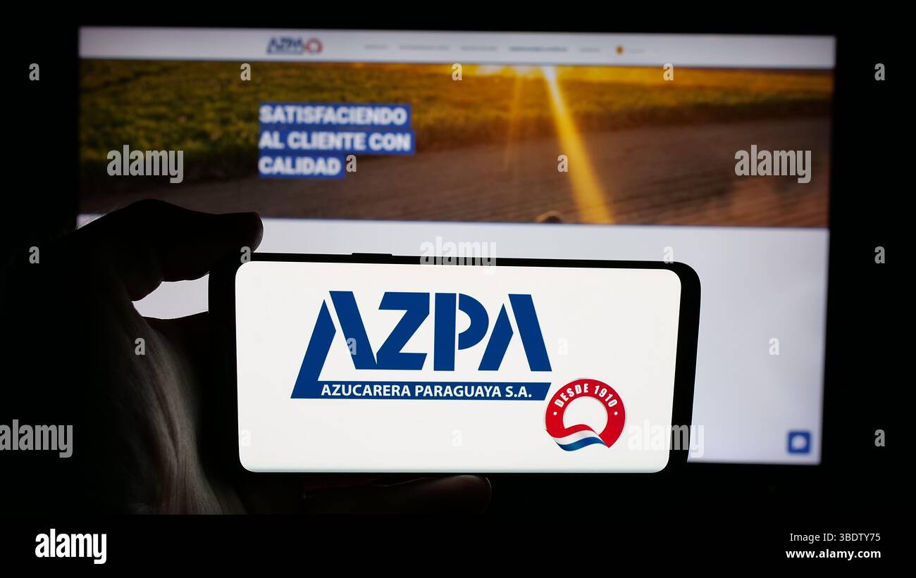 In this photo illustration, a person is holding a cellphone with the ...