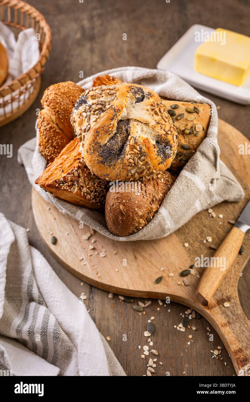 Assortment of bread, rolls and bakery products with salt, butter and ...