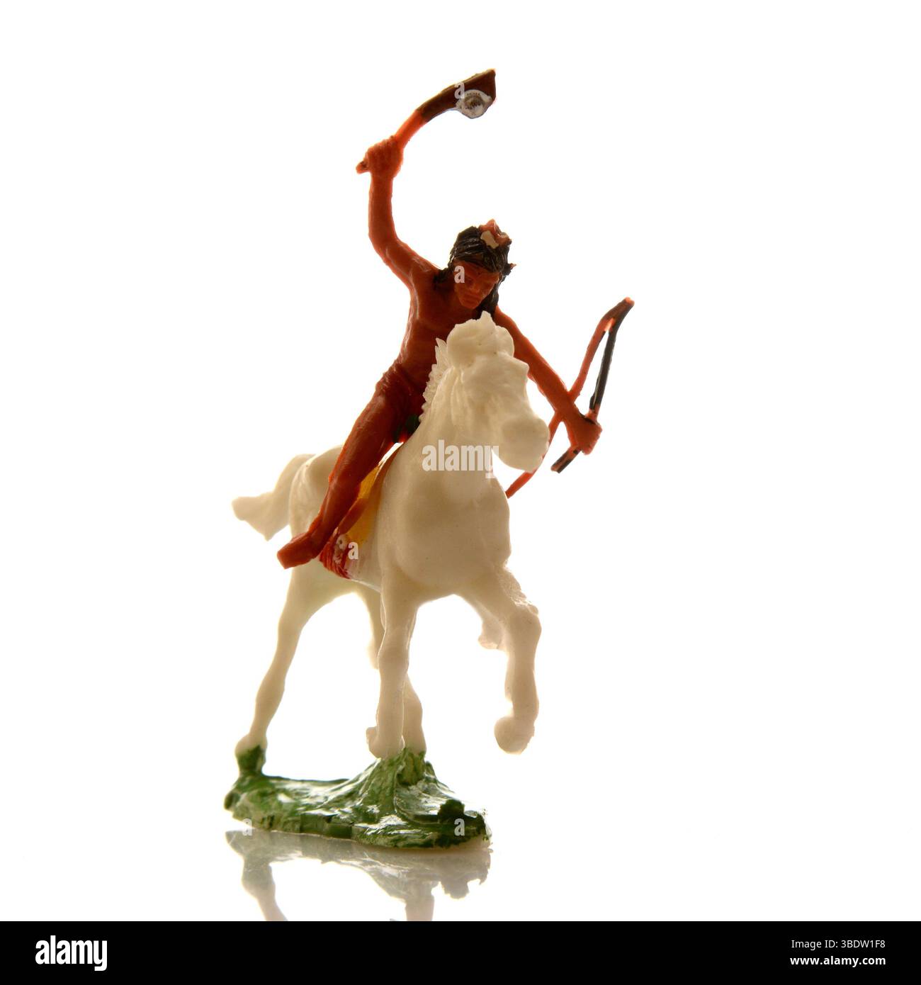 A handcrafted Indian toy soldier is captured riding a white horse with ...