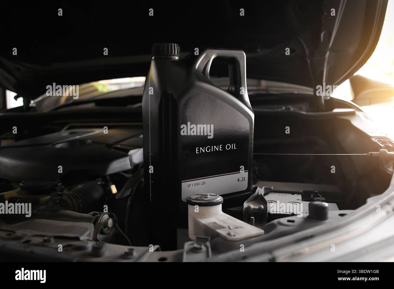 Engine Oil or Motor Oil, A black container sits in the open engine bay ...