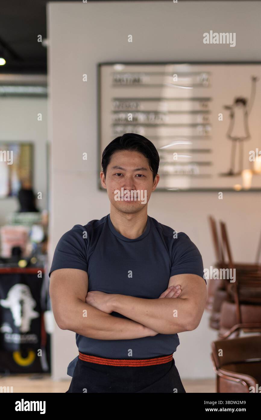 Athletic Asian man looking in camera, working as waiter Stock Photo - Alamy