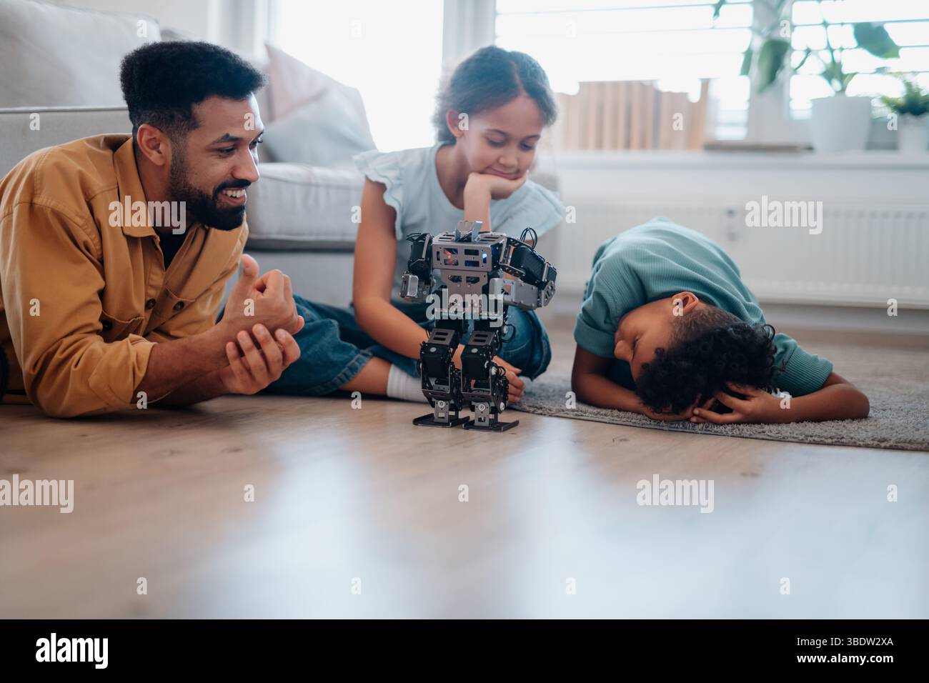 Father teaching kids about STEM, robotics, and discussing technology ...