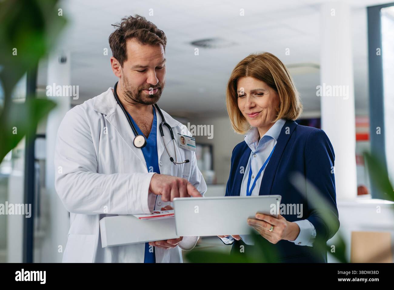 Female medical sales representative presenting medication to doctor ...