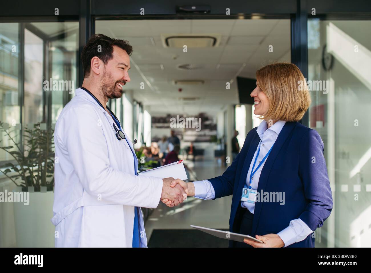 Confident female medical sales representative introducing herself to ...