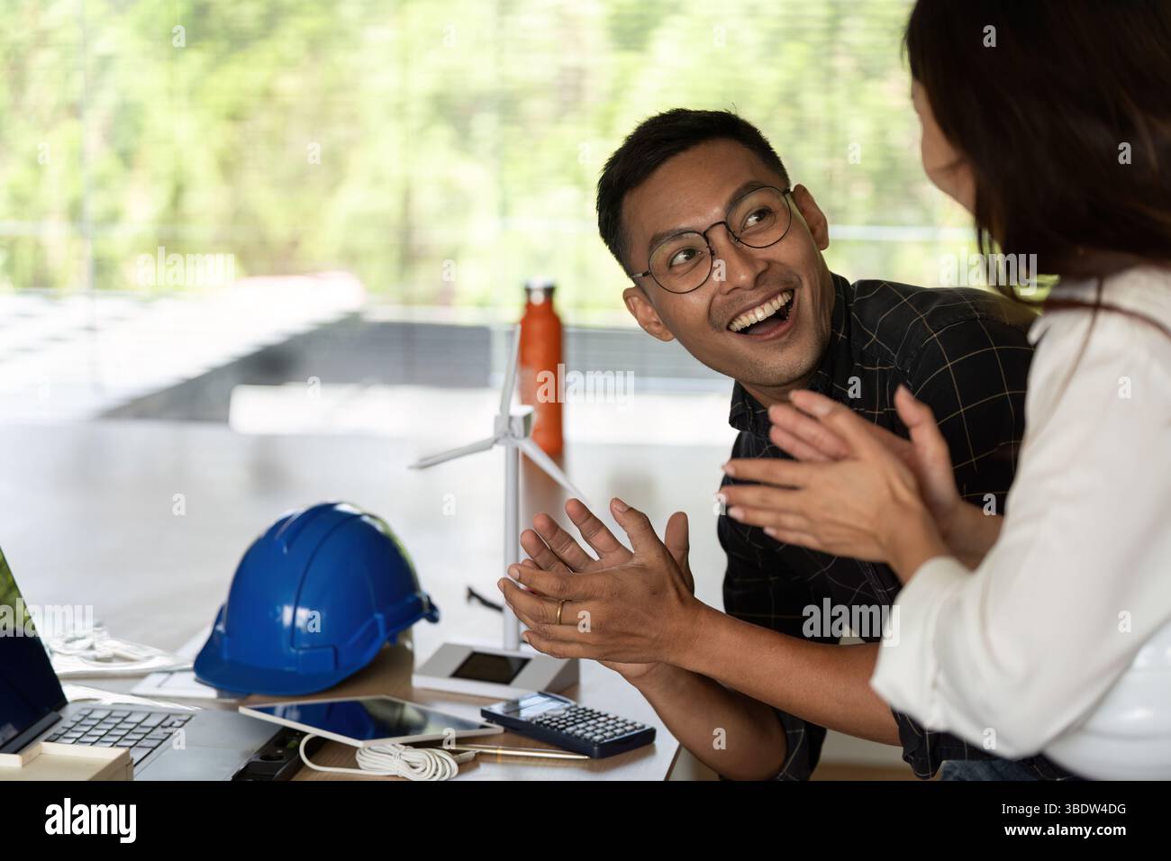 Sustainability and Teamwork. Engineer celebrating success with a ...