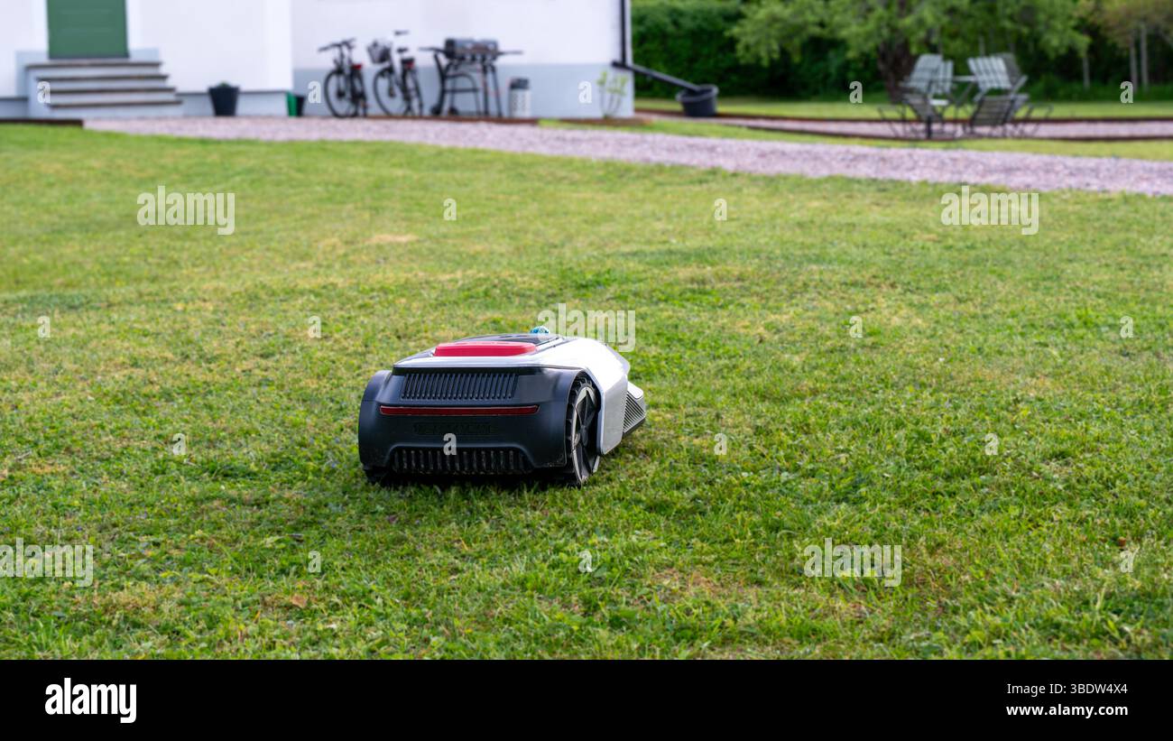Robotic lawnmower without perimeter wire cutting perfect lawn Stock ...