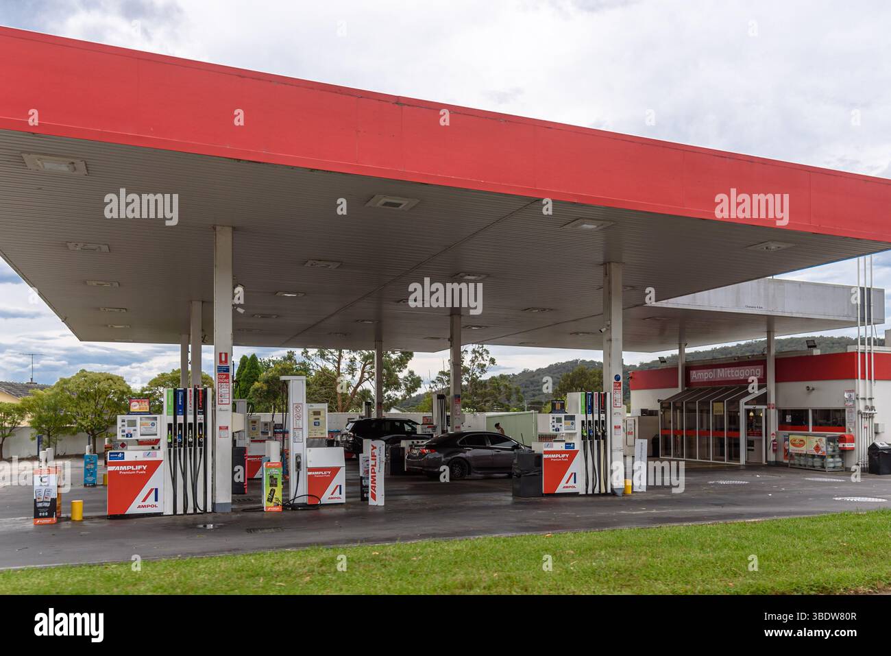 Fuel pumps at an Ampol service station on a cloudy day Stock Photo - Alamy