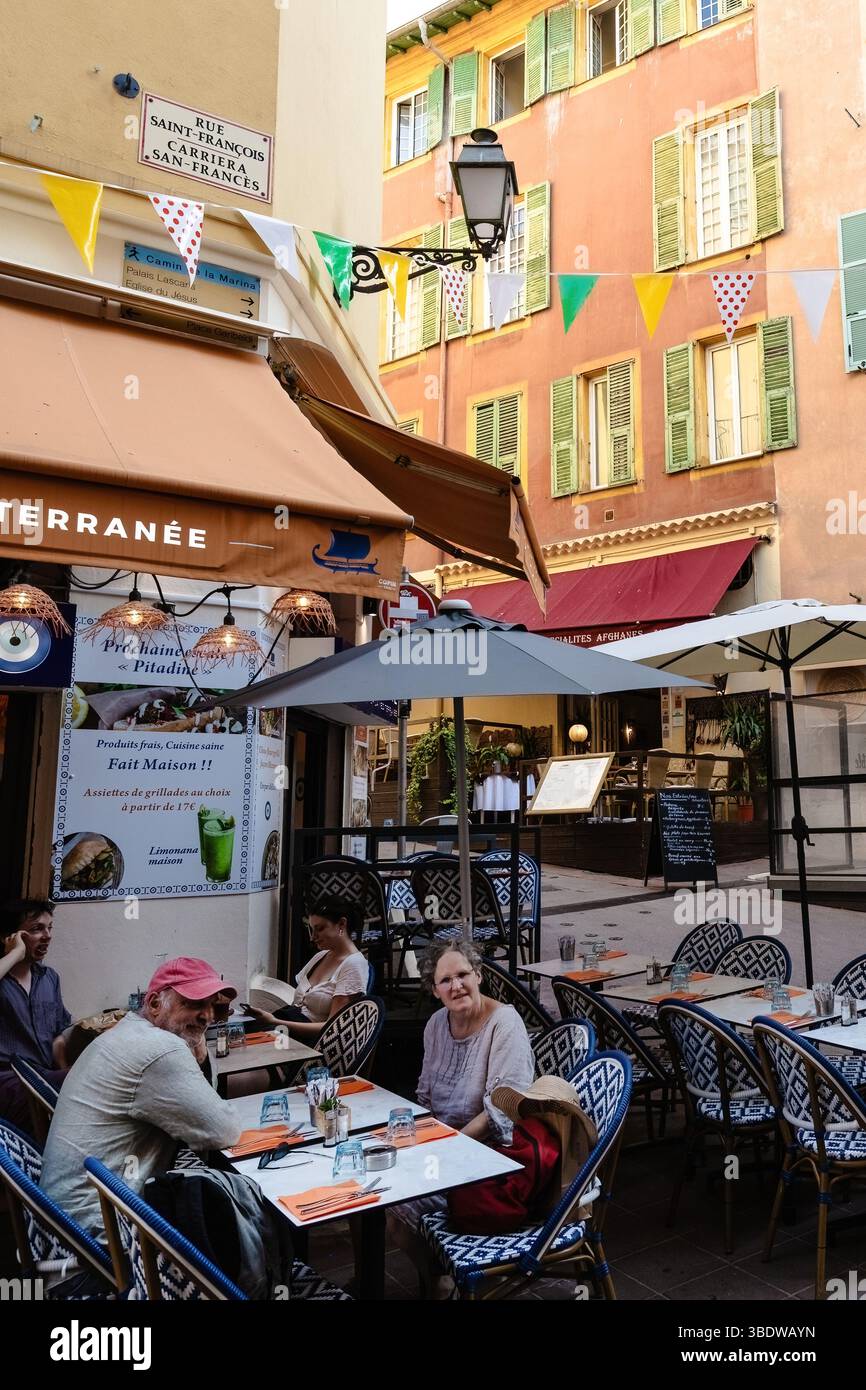 Evening time in Nice old town people at the restaurant for the dinner ...