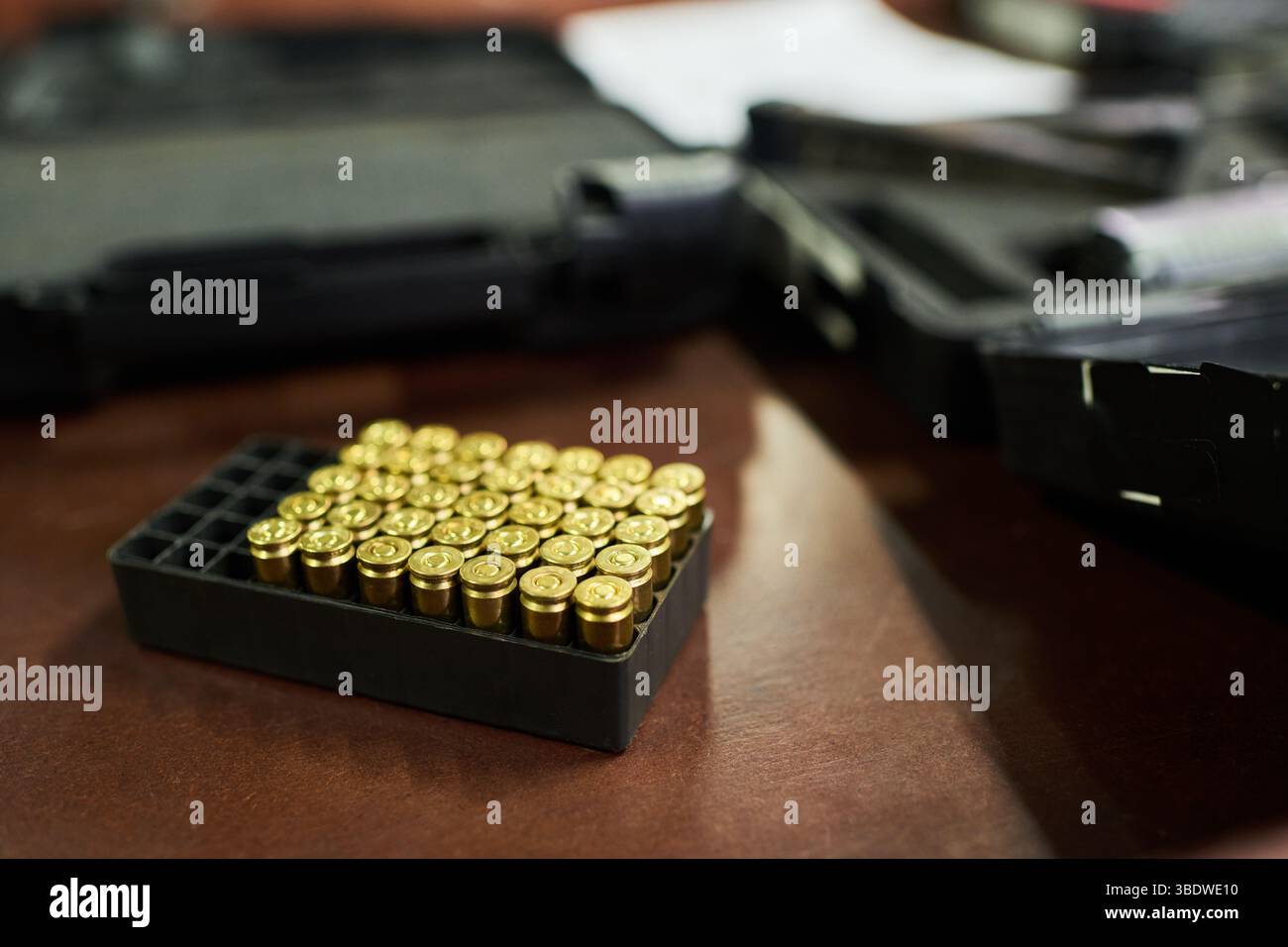 Bullet casings positioned in organized rows within a black box, placed ...