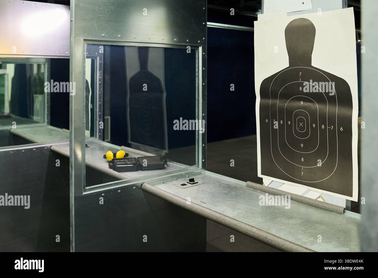 Tray at public shooting range with several target silhouettes hanging ...