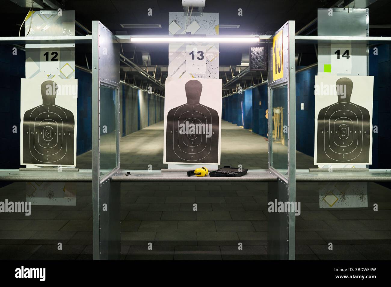Indoor shooting range featuring targets on multiple lanes for ...