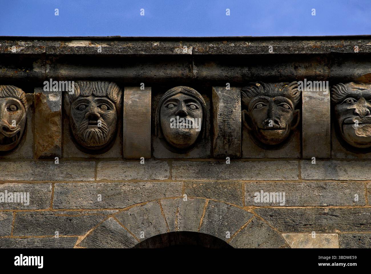 Grimacing and glaring grotesque sculpted faces staring down from ...