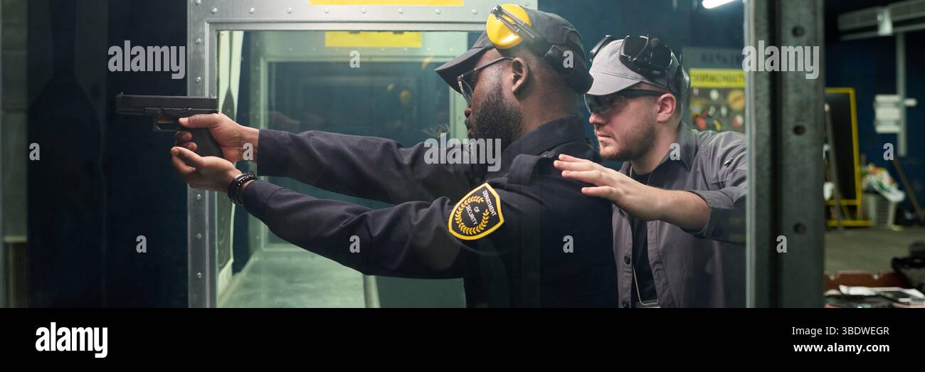 Police officer practicing shooting at firing range under guidance of ...