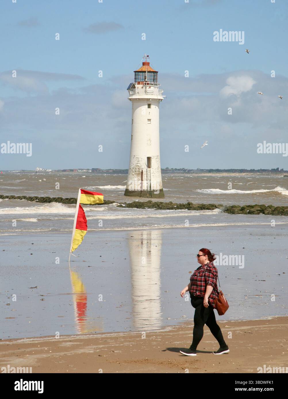 Old woman strolling on beach hi-res stock photography and images - Alamy