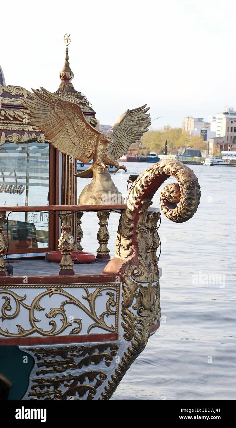 Ornate golden eagle sculpture with wings on a traditional boat Stock ...