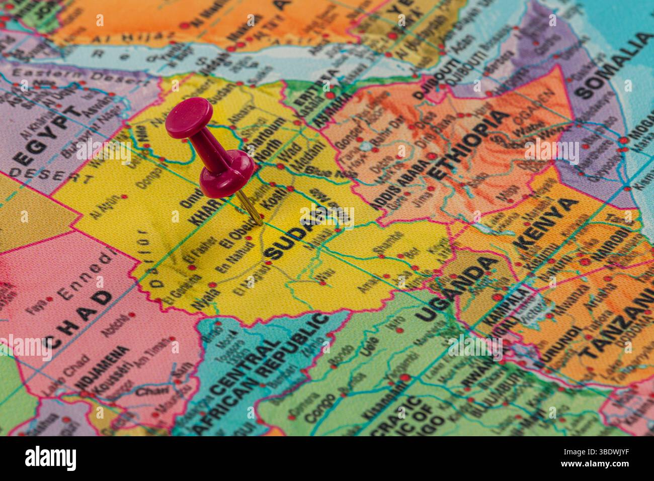 A bright map of Africa features a red pin marking Sudan. The vibrant ...