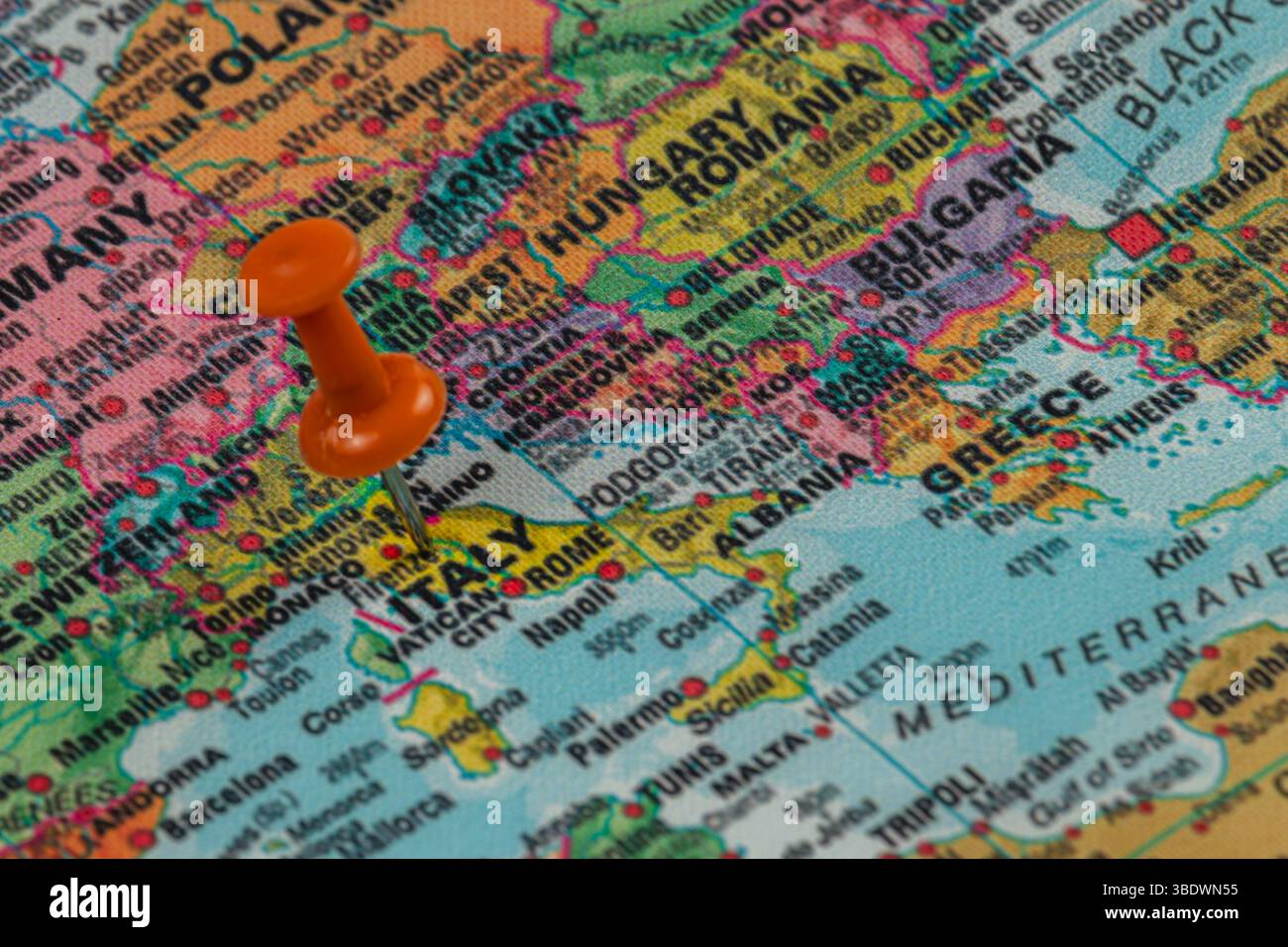 An orange pin marks Italy on a detailed map highlighting various ...