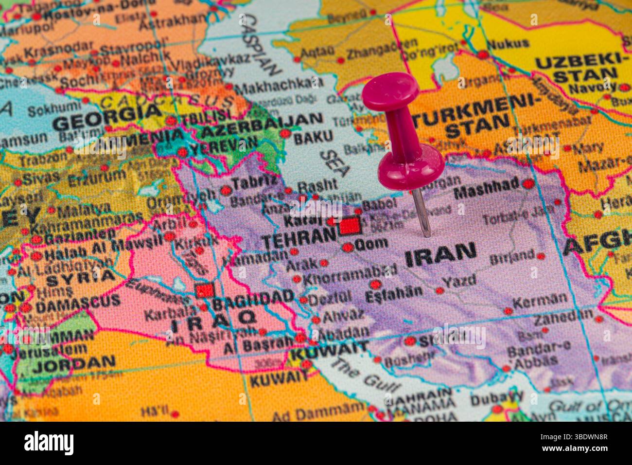 A bright pink pin points to Tehran on a detailed map of Iran ...