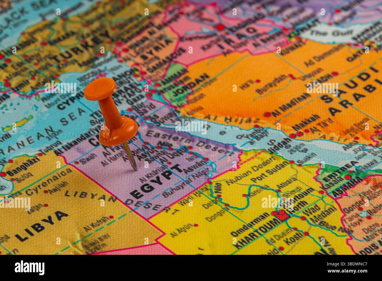 A detailed map displays Egypt prominently, marked with a bright orange ...