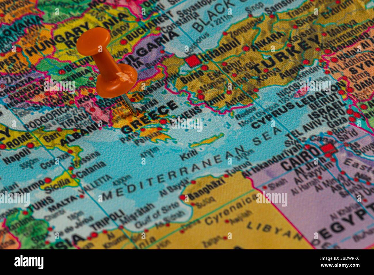 A bright orange pin indicates a specific location on a colorful map ...