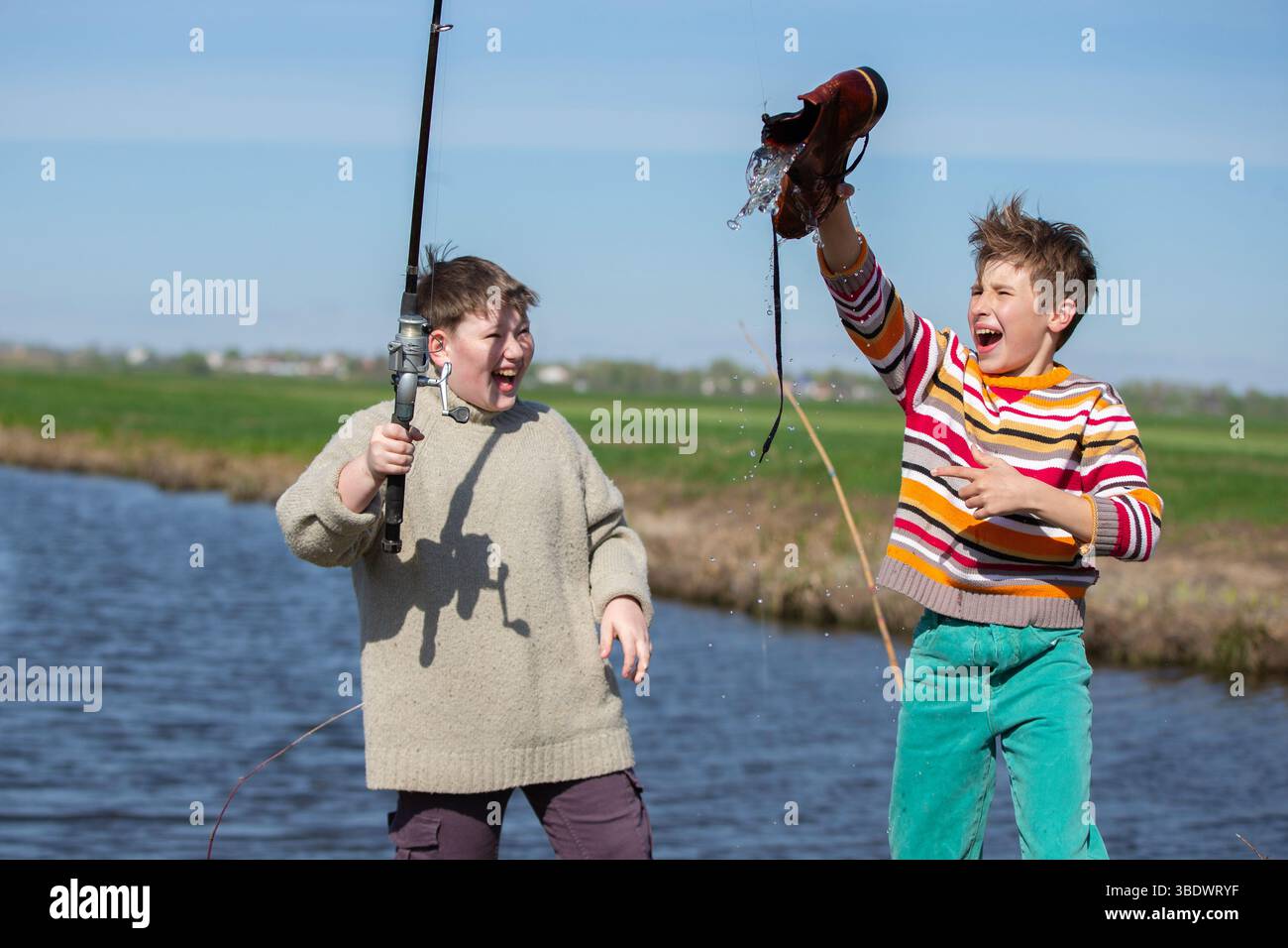 Funny fishing. Two of the boy's friends hooked an old shoe with a ...