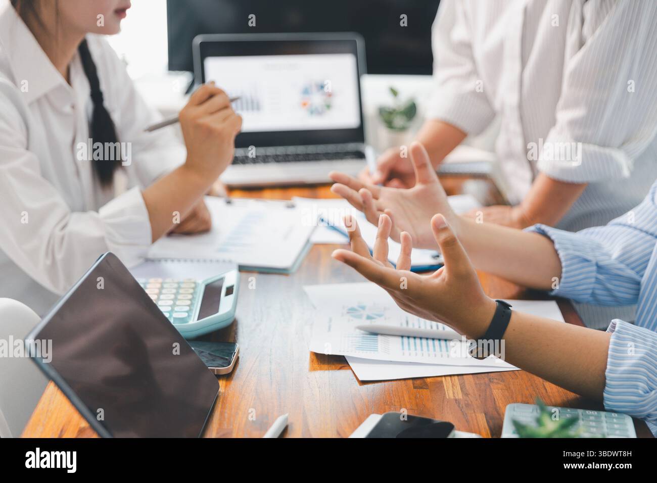 Teamwork with business people analysis cost graph on desk at meeting room. partnership analysis ...