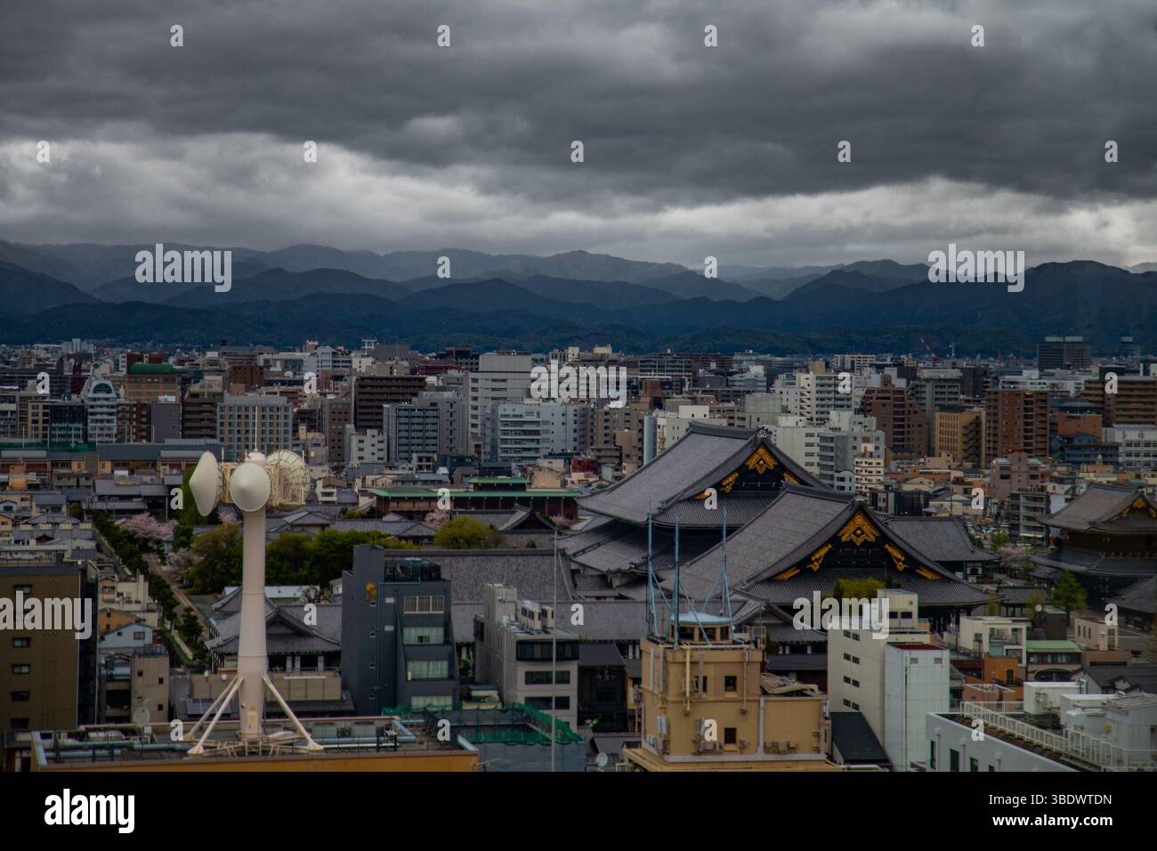 Kyoto cityscape with a traditional pagoda rising above rooftops and ...