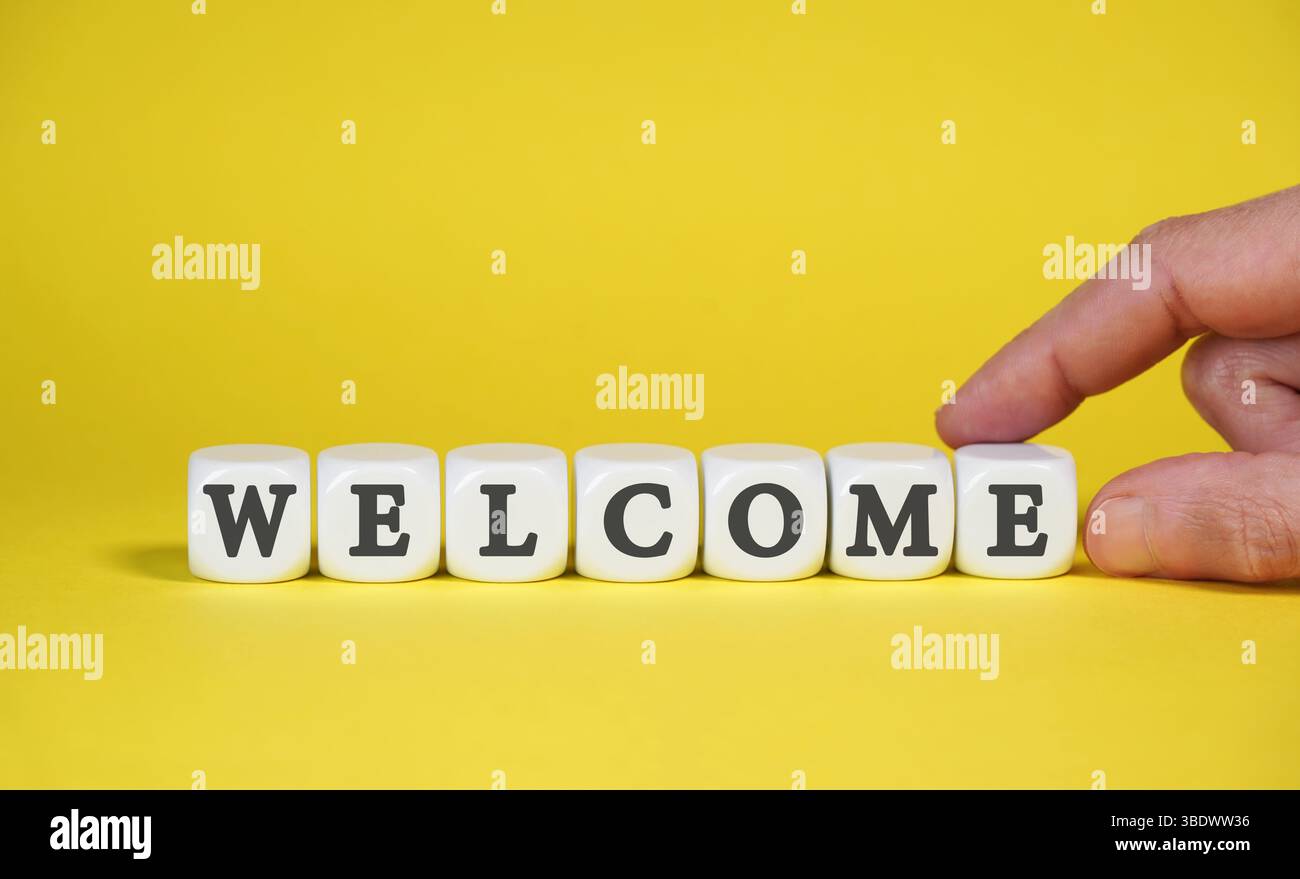 Welcome sign with word and lettering on white dices on yellow ...
