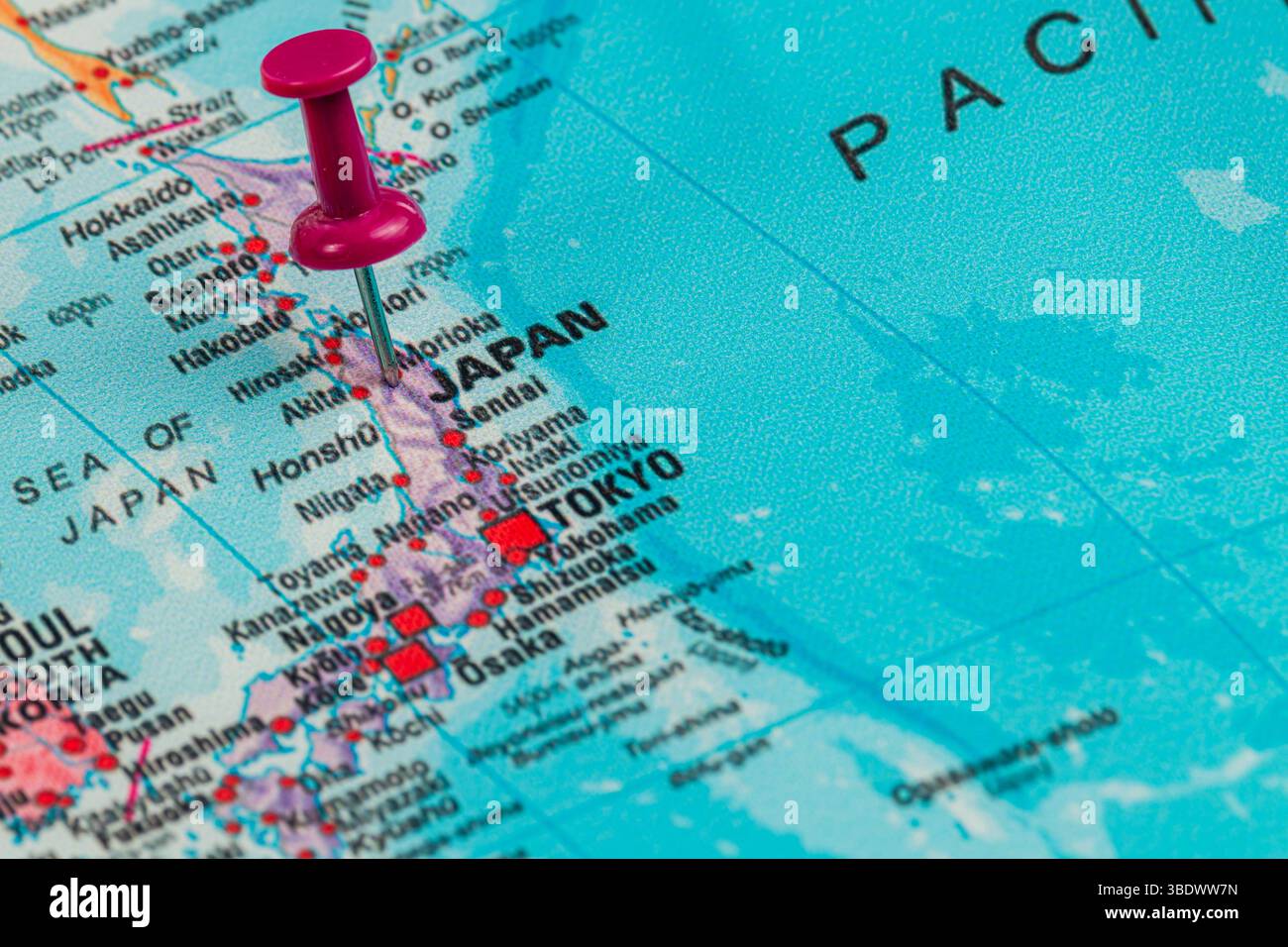 A vibrant map highlights Japan's geography with a pink pushpin marking ...