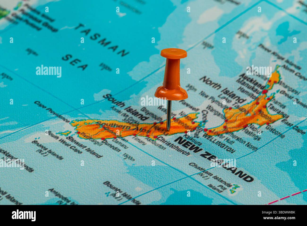 A vibrant map highlights the islands of New Zealand, marked by an ...