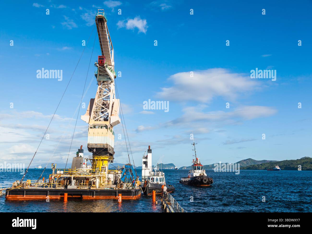 Installation of a large floating crane with the help of sea tugs, on a ...