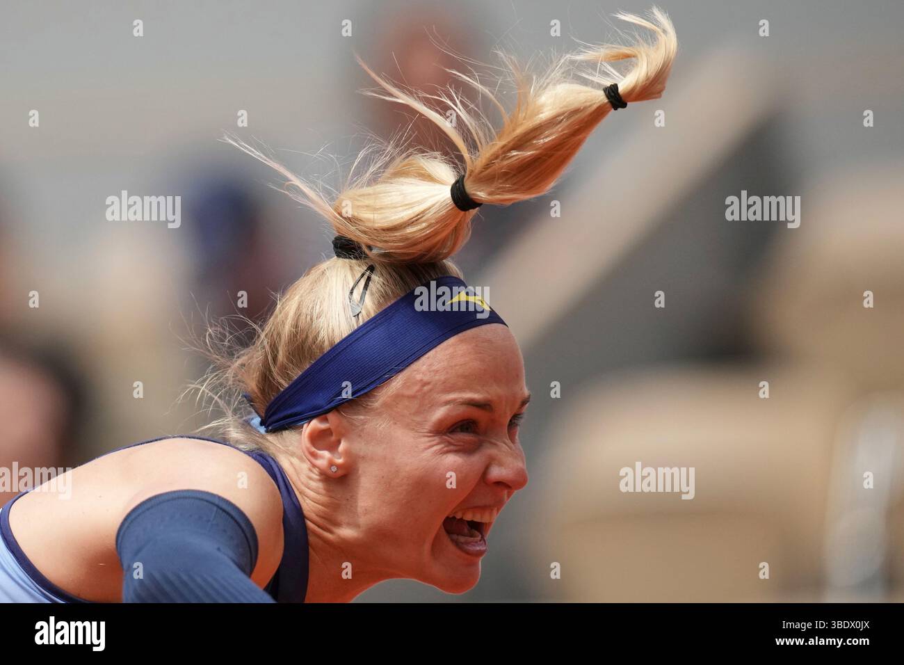 Slovakia's Rebecca Sramkova serves against Poland's Iga Swiatek during ...