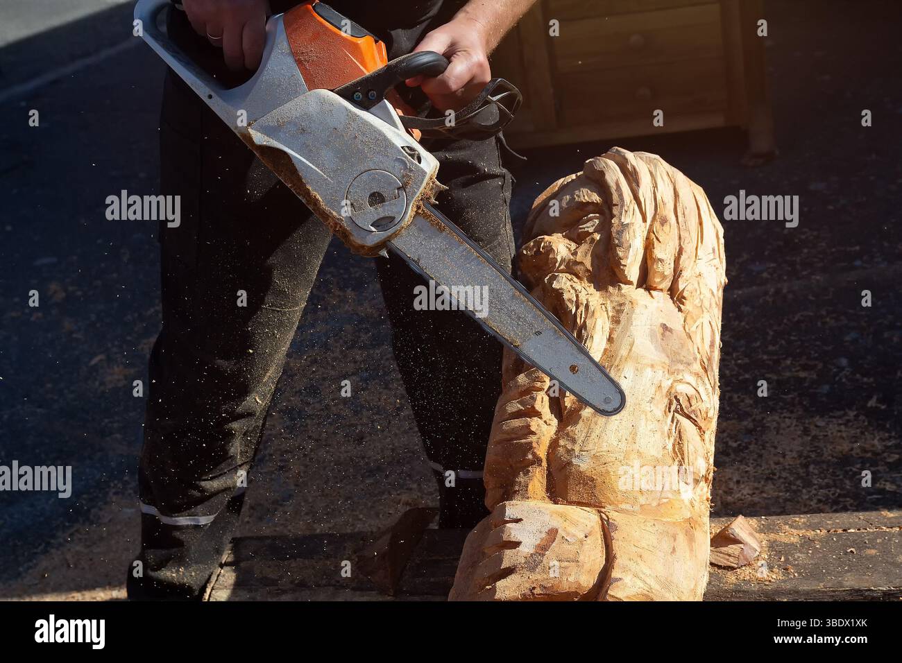 Man using chain saw to create wood carving. Skill and hobby Stock Photo ...