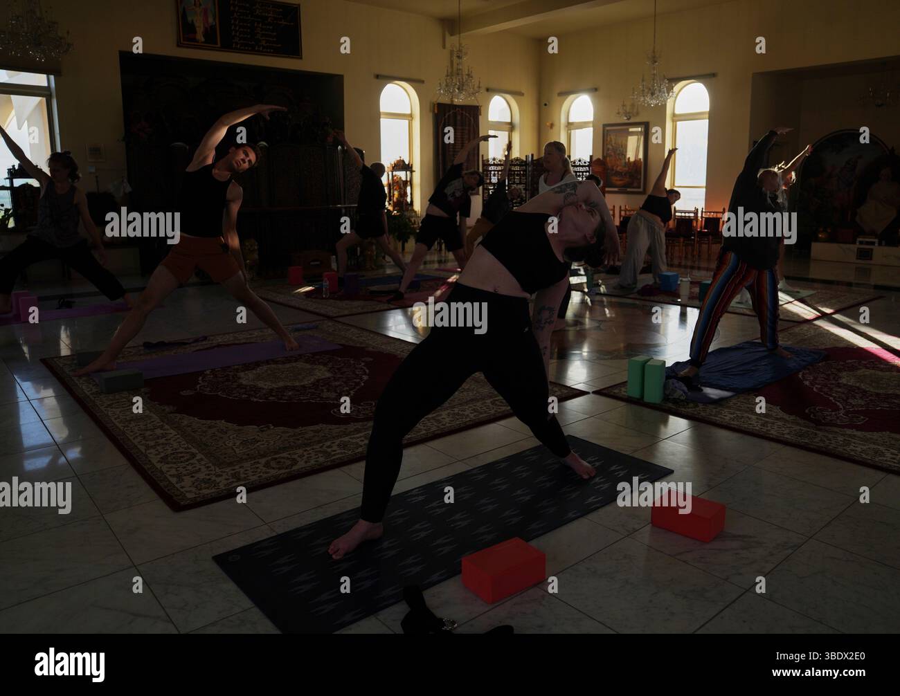 Jamie Waterman, center, and others attend a 90-minute yoga class at ...