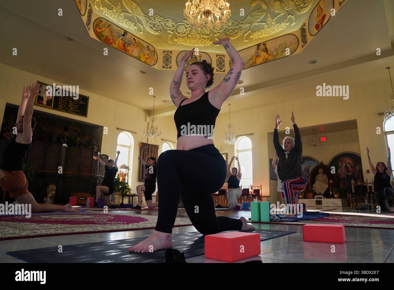 Jamie Waterman practices yoga during a 90-minute session at the Shri ...