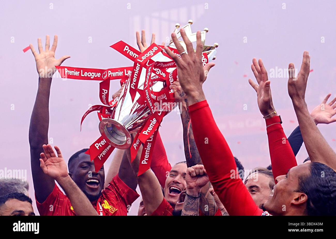 Liverpool players celebrate with the Premier League trophy after the ...