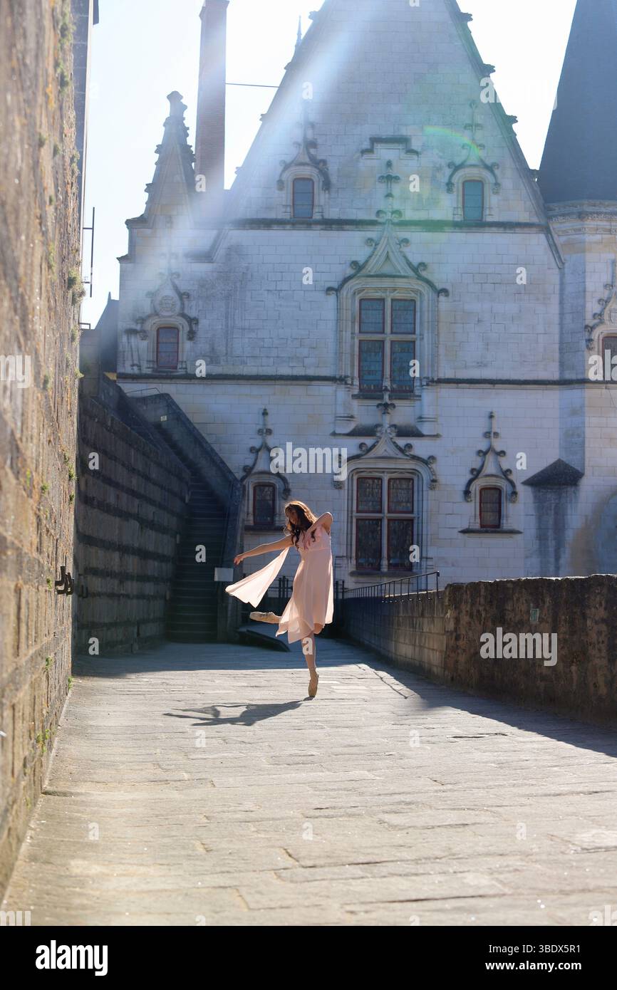 Ballerina dancing in sunlight near historic castle architecture Stock ...